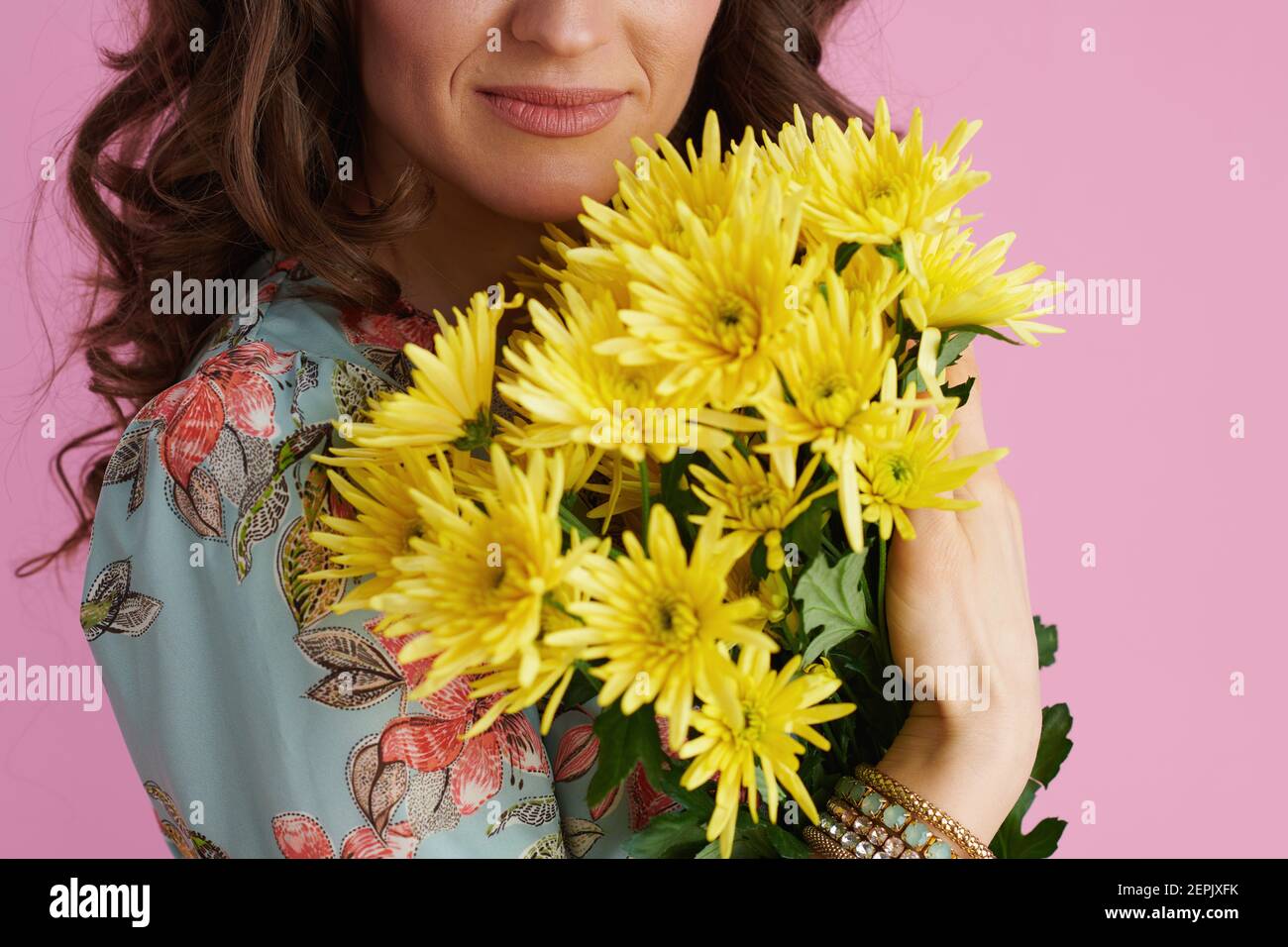 Closeup on relaxed female with yellow chrysanthemums flowers against ...
