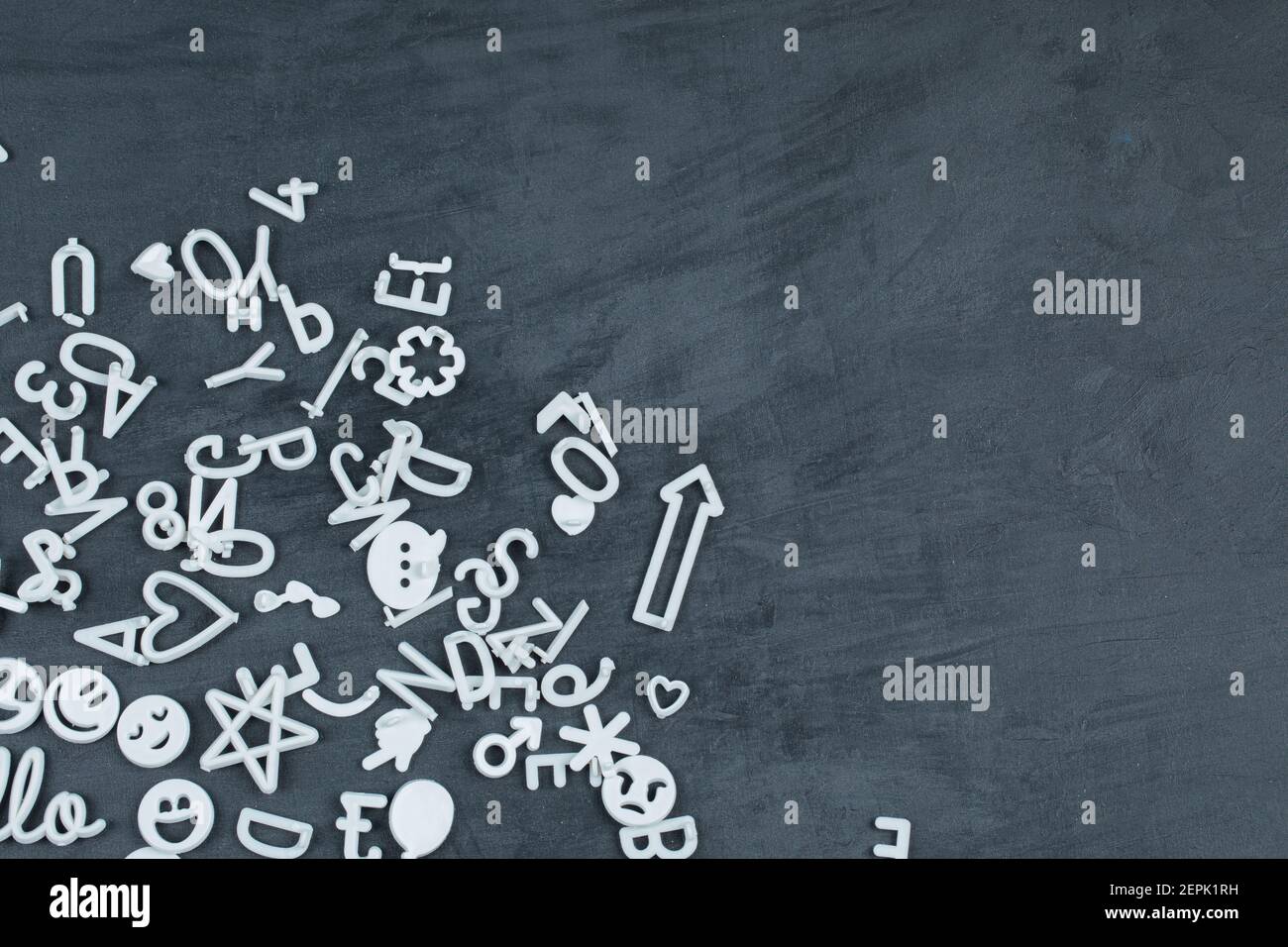 Detachable white color letters, icons and pins on black background ...