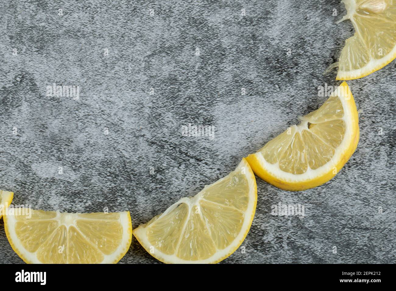 Slices of sour lemon on a gray background Stock Photo - Alamy