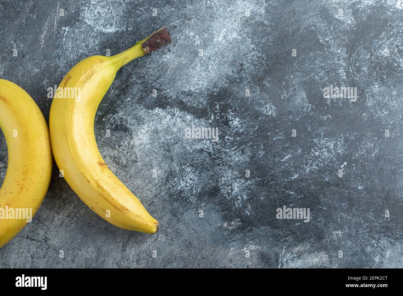 Top view of Two ripe bananas over grey background Stock Photo - Alamy