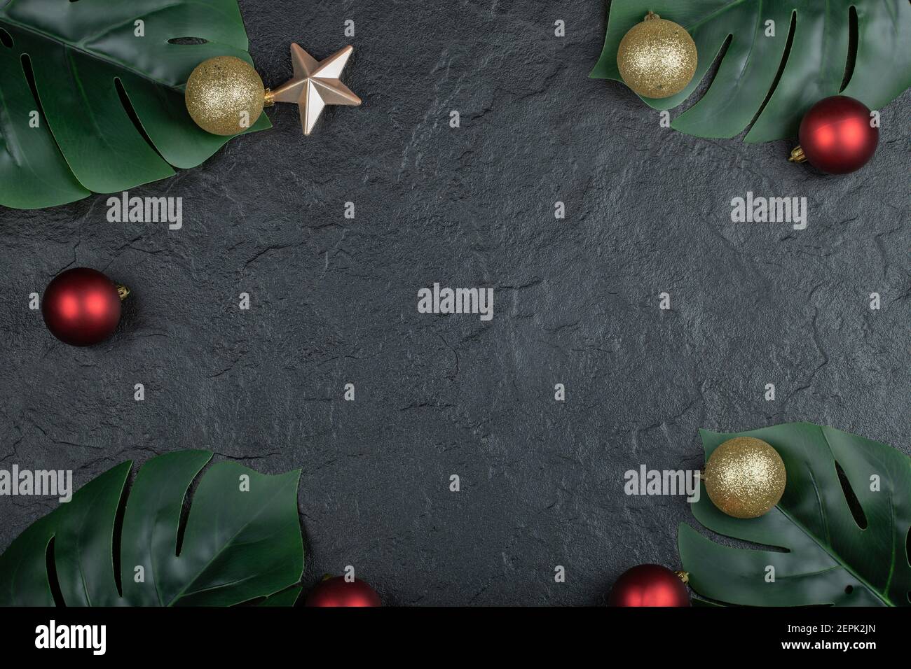 Dark background with Christmas baubles and leaves Stock Photo - Alamy