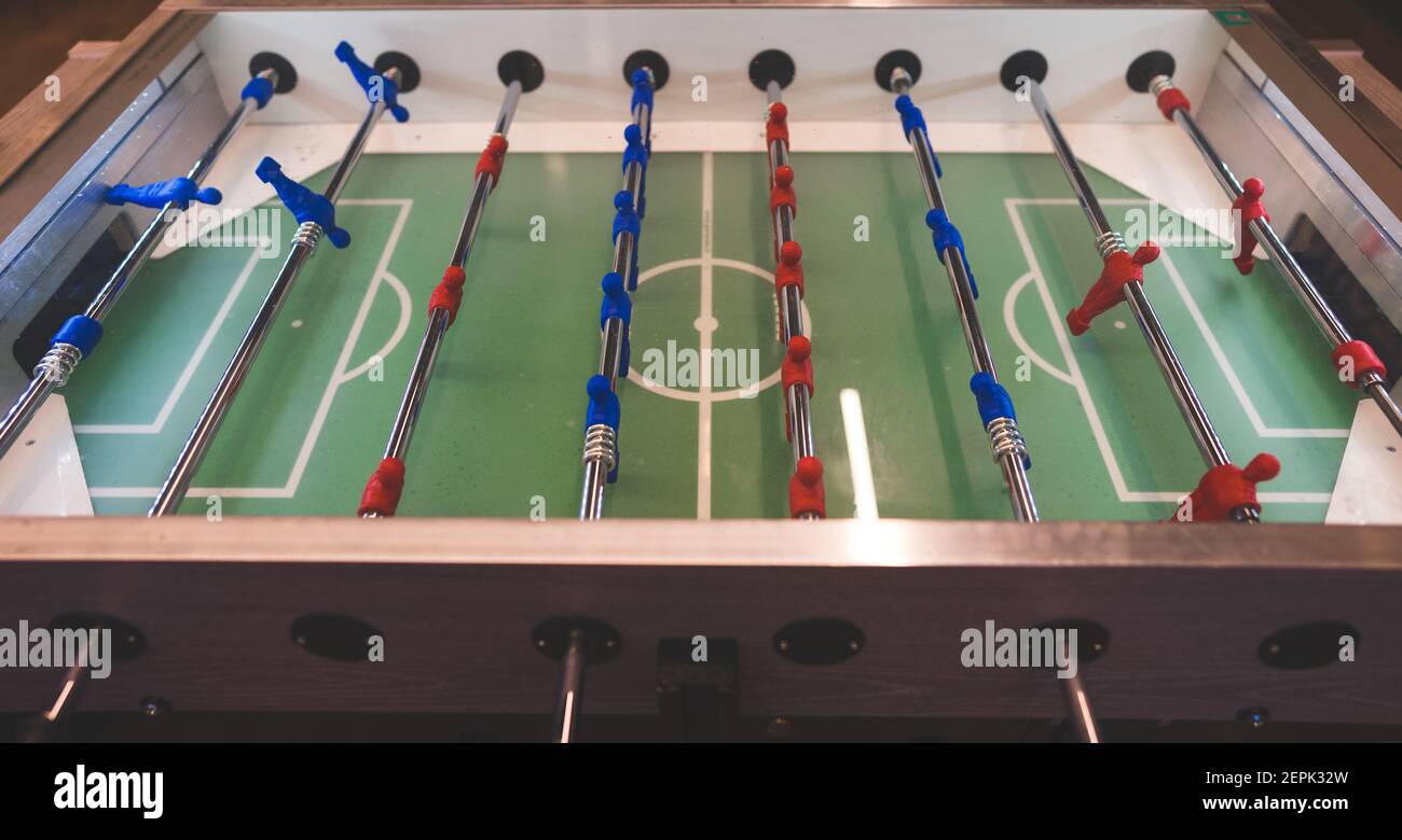 Table football game with red and blue players Stock Photo - Alamy