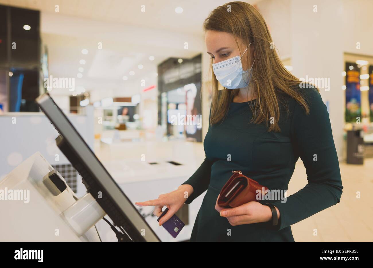 Woman using a self-service terminal in mall Stock Photo - Alamy