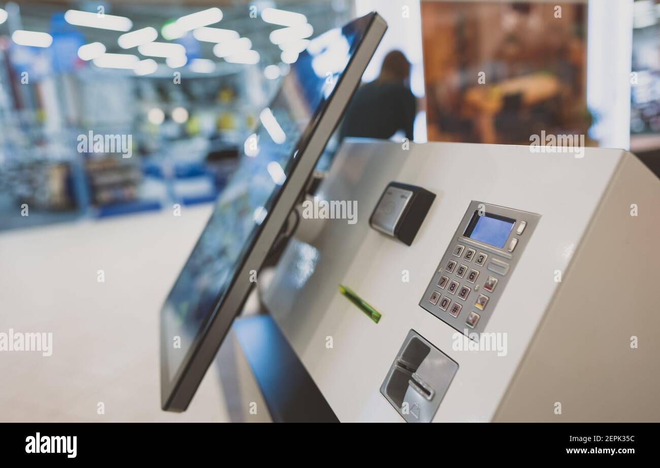 Modern self-service terminal in city mall Stock Photo - Alamy