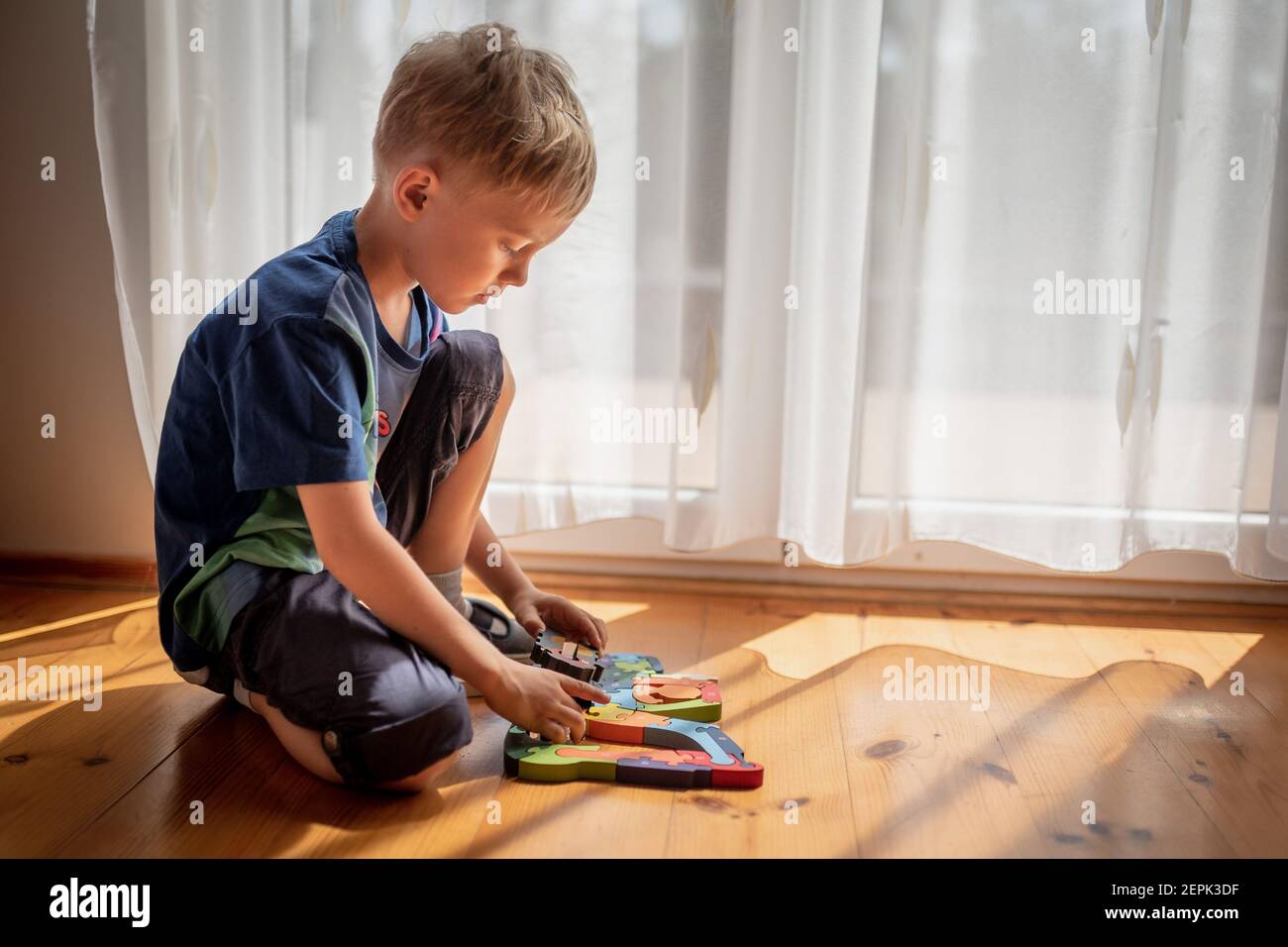 5-6 old boy play with blocks puzzle Stock Photo - Alamy