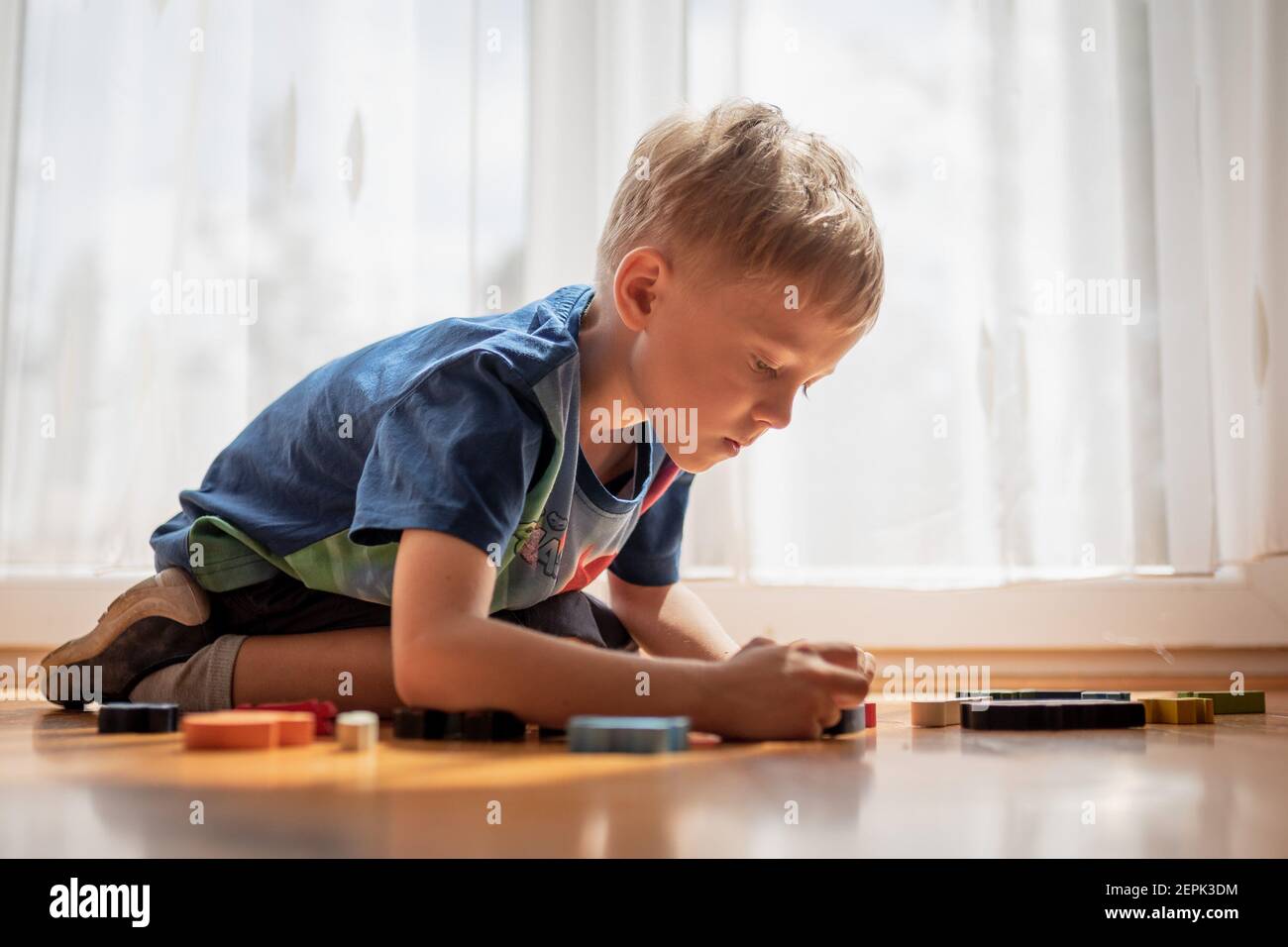 5-6 old boy play with blocks puzzle Stock Photo - Alamy