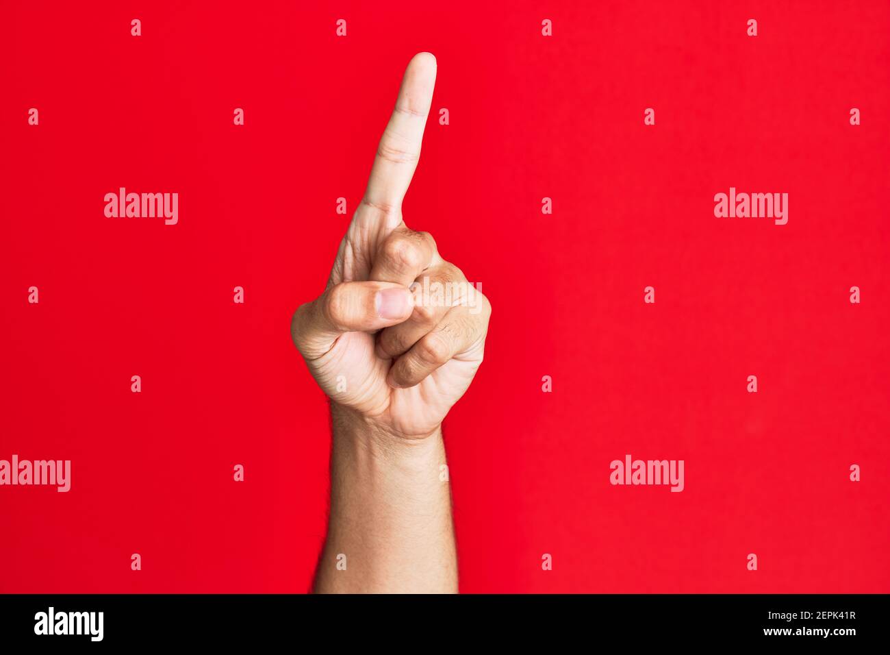 Arm of caucasian white young man over red isolated background counting ...