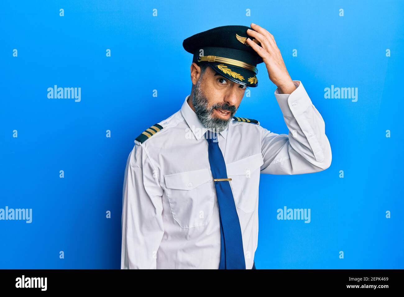 Middle age man with beard and grey hair wearing airplane pilot uniform ...