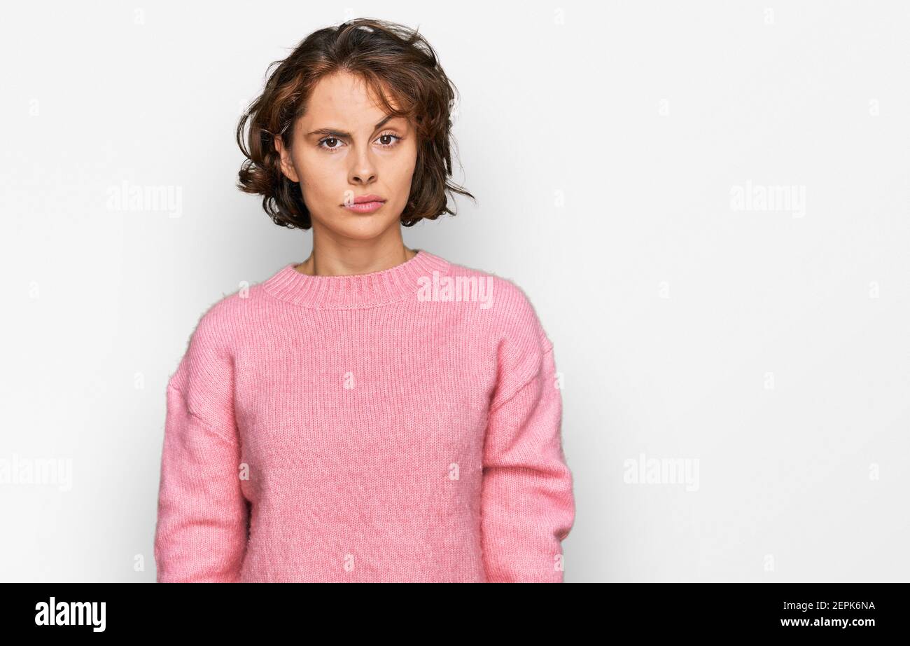 Young hispanic woman wearing casual clothes skeptic and nervous ...
