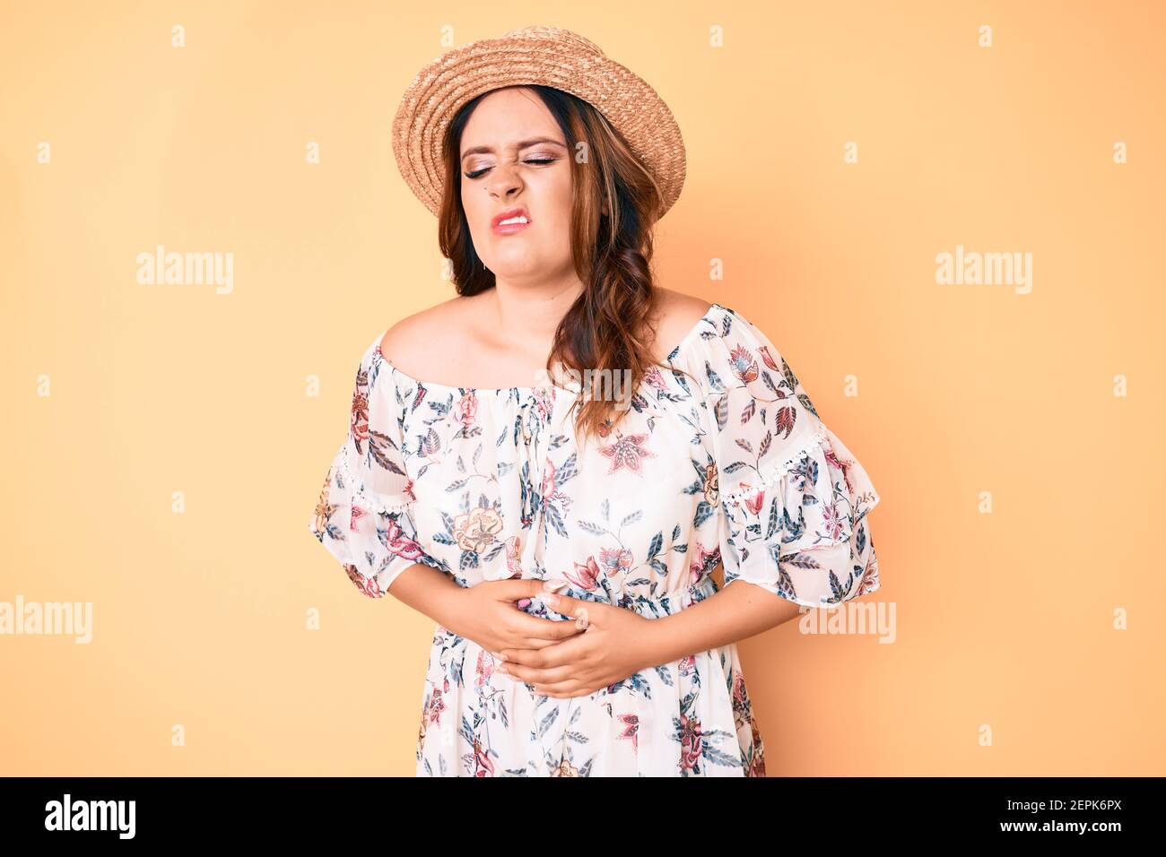 Young beautiful caucasian woman wearing summer dress and hat with hand ...