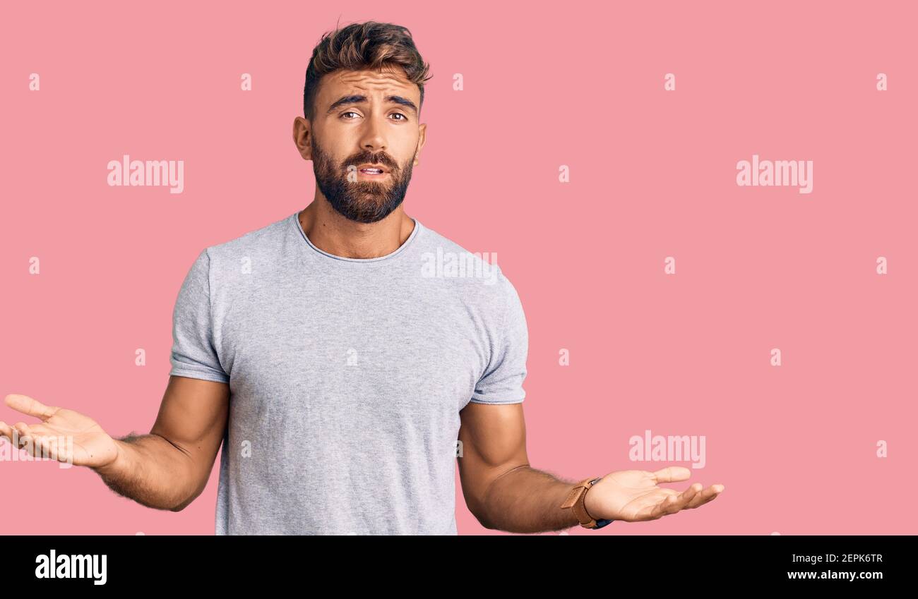 Young hispanic man wearing casual clothes clueless and confused with ...
