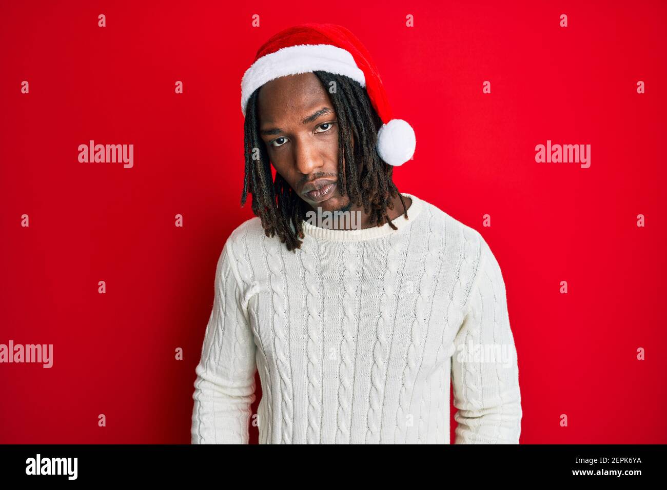 African American Man With Braids Wearing Christmas Hat Depressed And
