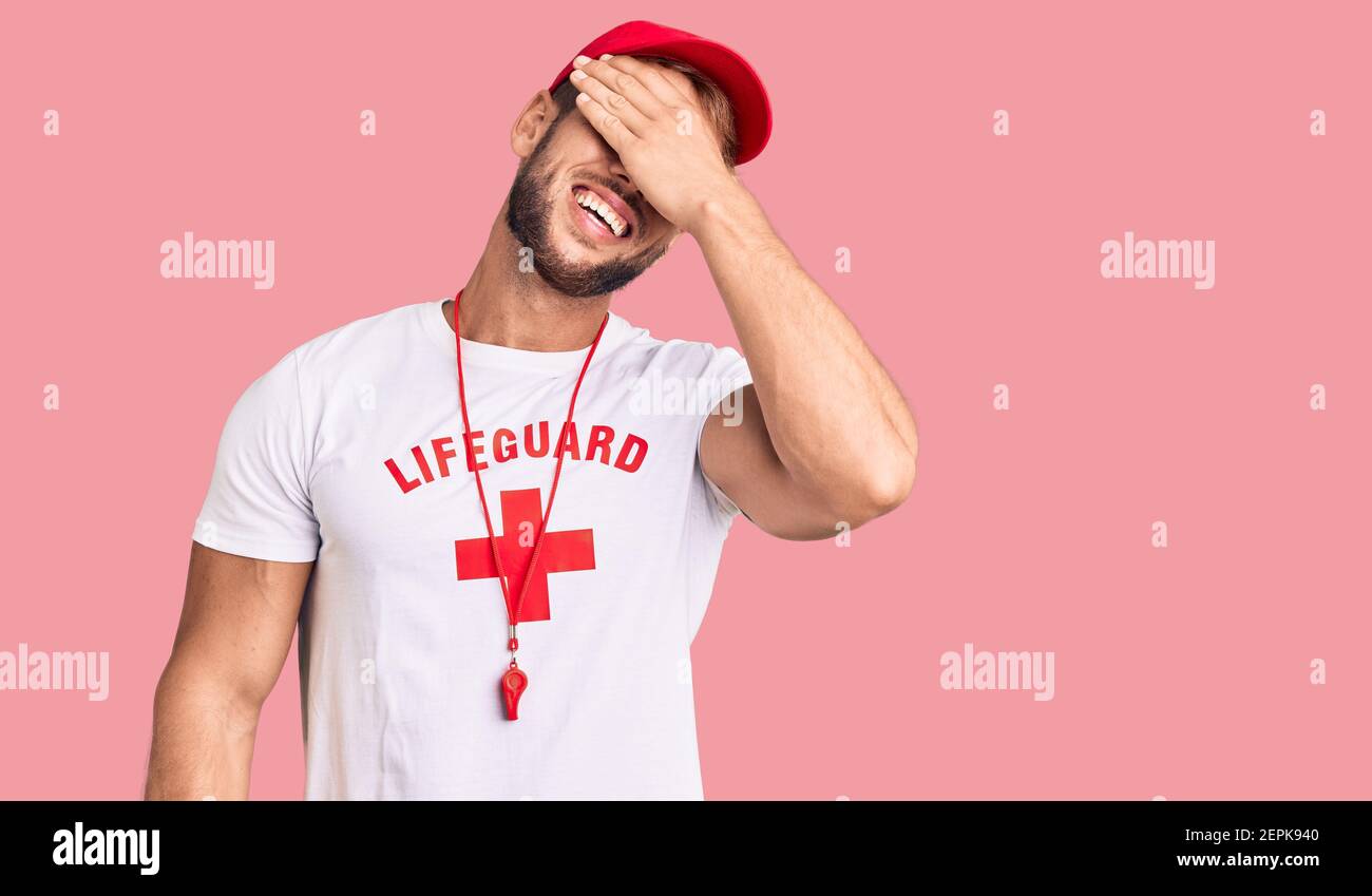 Young caucasian man wearing lifeguard t shirt holding whistle smiling ...