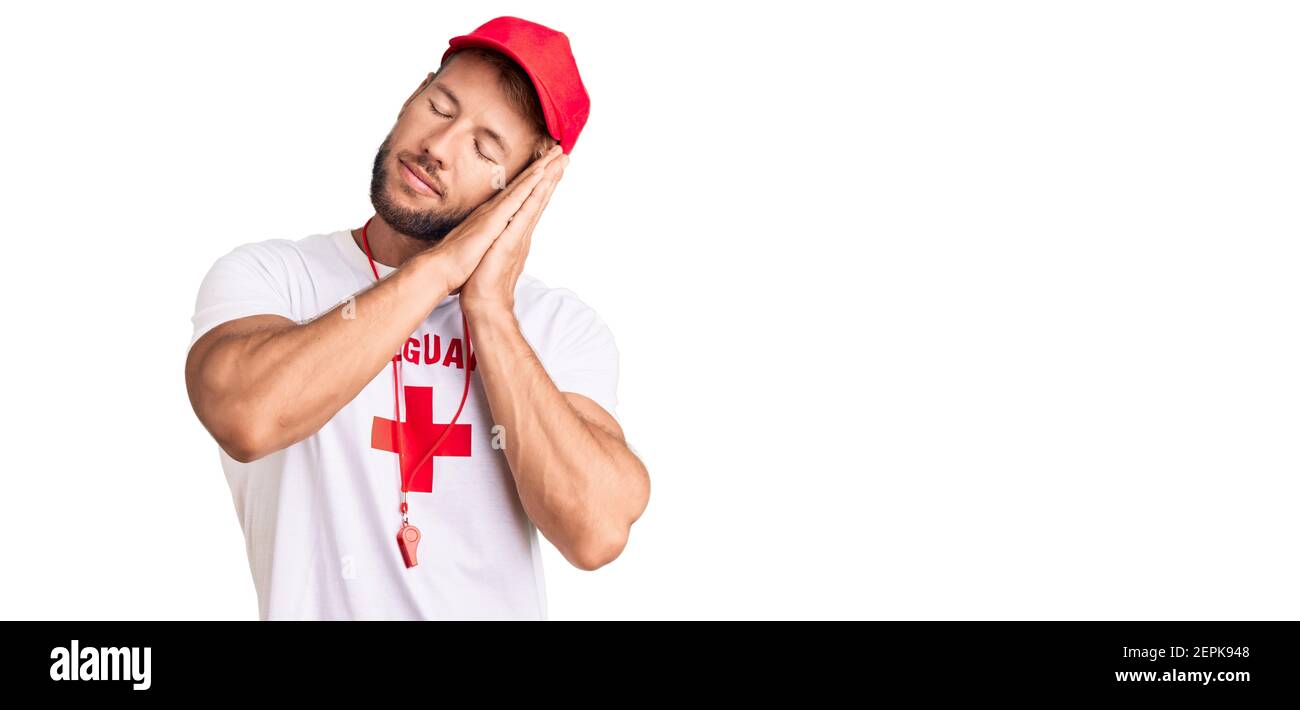 Young caucasian man wearing lifeguard t shirt holding whistle sleeping ...
