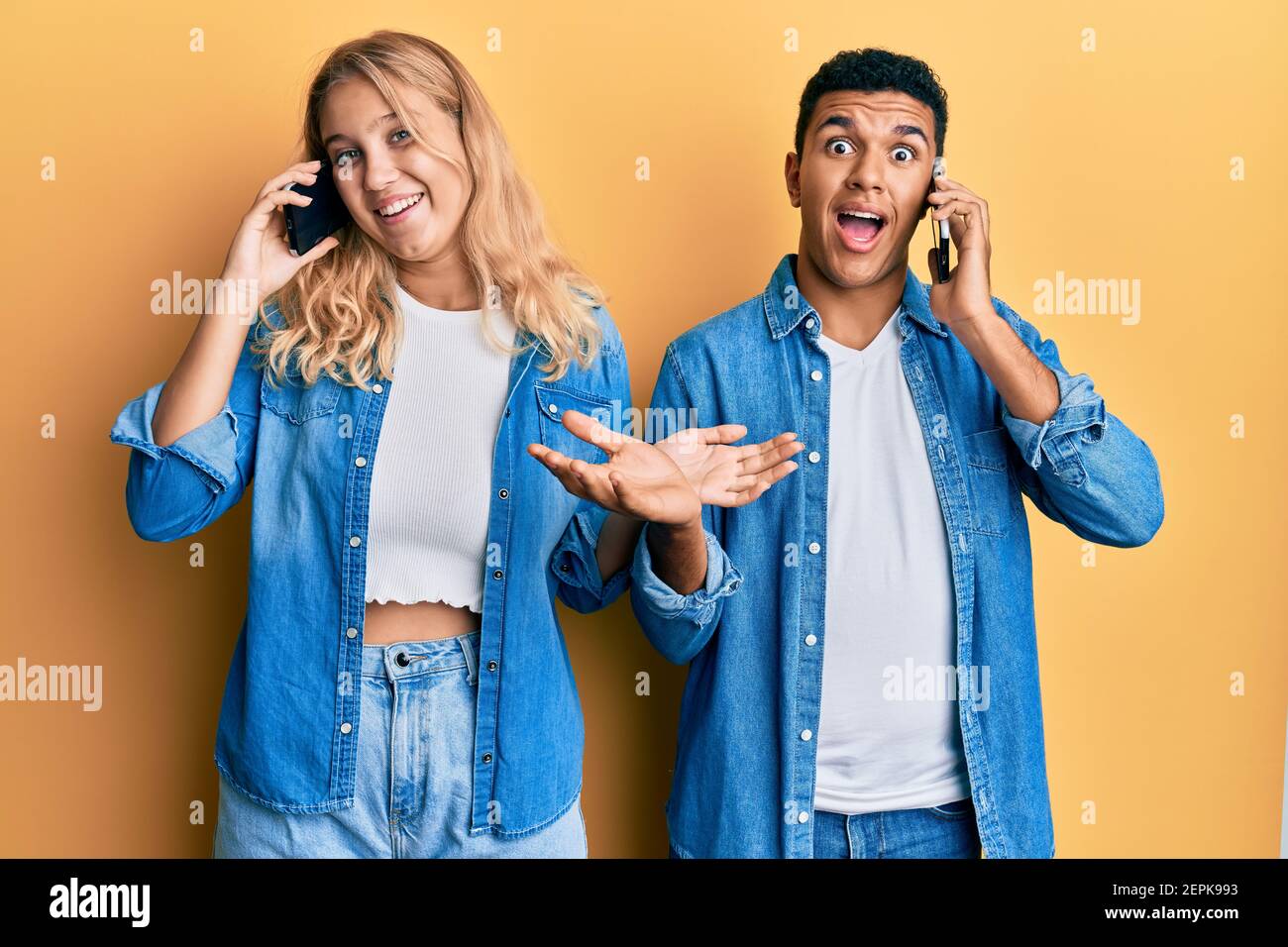 Young interracial couple having conversation talking on the smartphone ...
