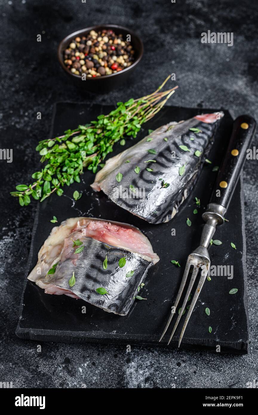 Cold smoked mackerel fish with herbs. Black background. Top view Stock ...