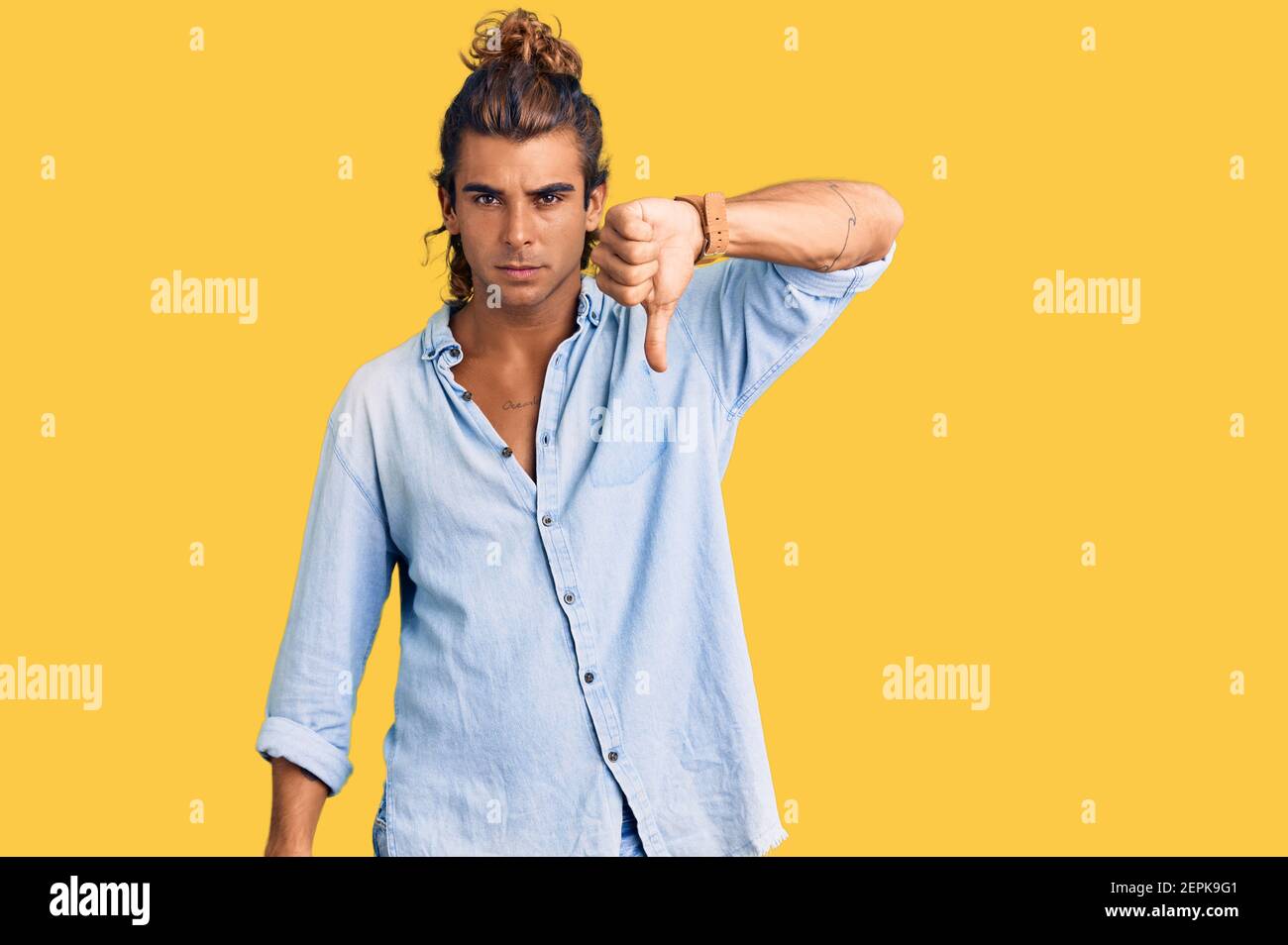 Young hispanic man wearing summer style looking unhappy and angry ...