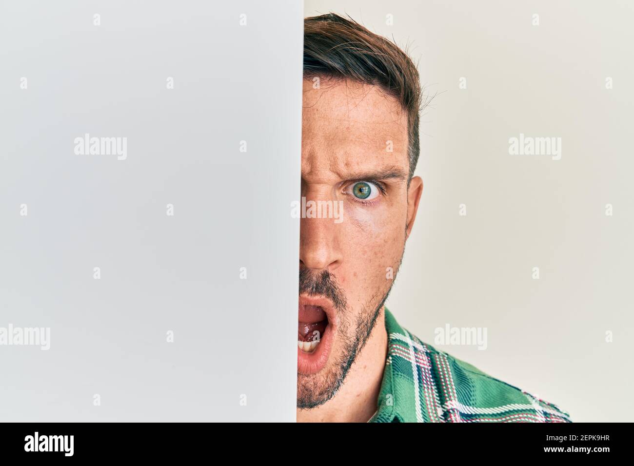 Handsome Man With Beard Holding Blank Empty Banner Covering Half Face