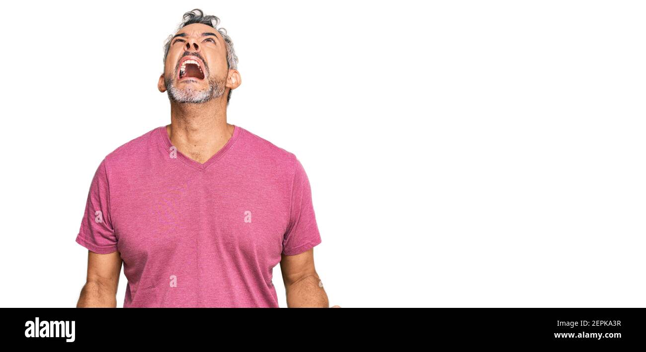 Middle age grey-haired man wearing casual clothes angry and mad ...