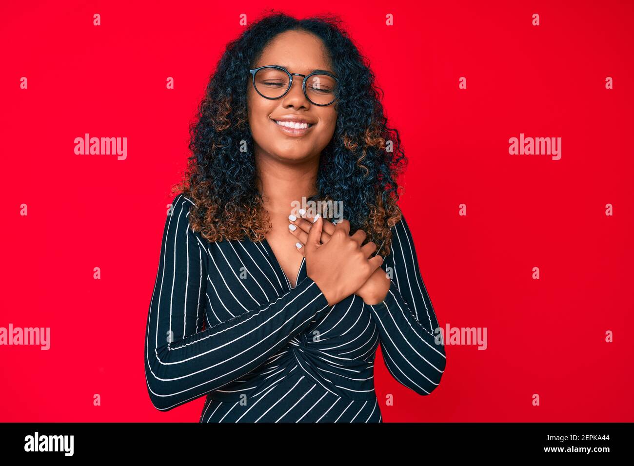 Young african american woman wearing casual clothes and glasses smiling ...