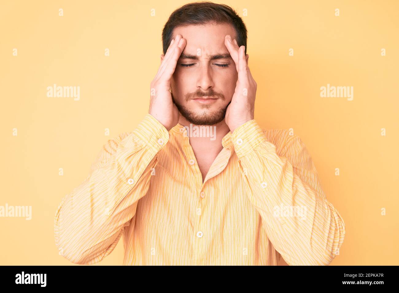 Young handsome man wearing casual clothes with hand on head for pain in ...