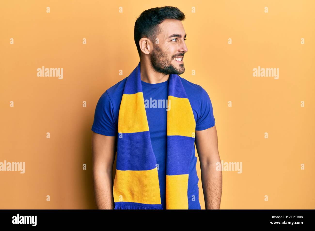 Young hispanic man football hooligan cheering game looking to side ...