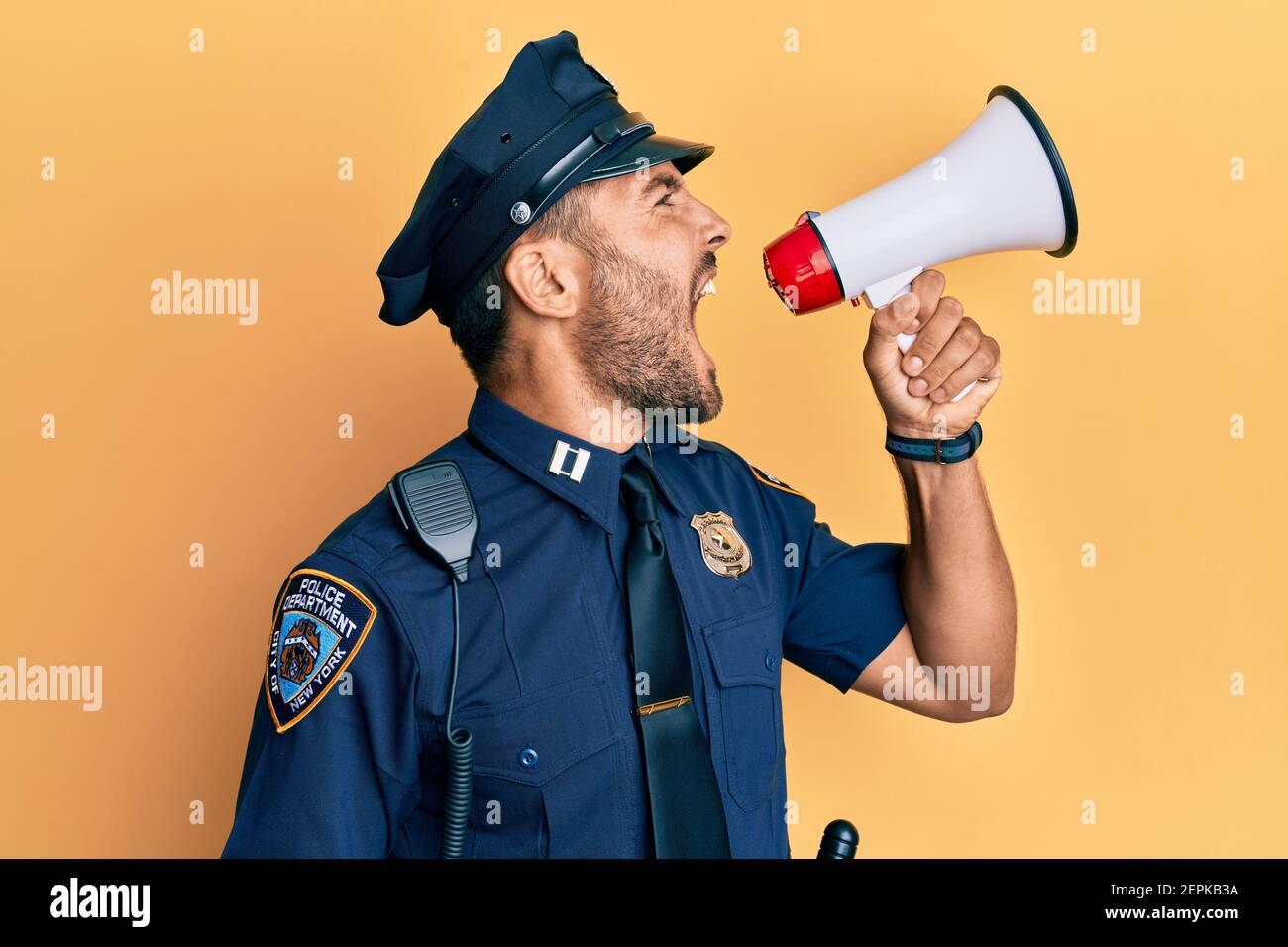 American police officer shouting through megaphone, yelling and ...