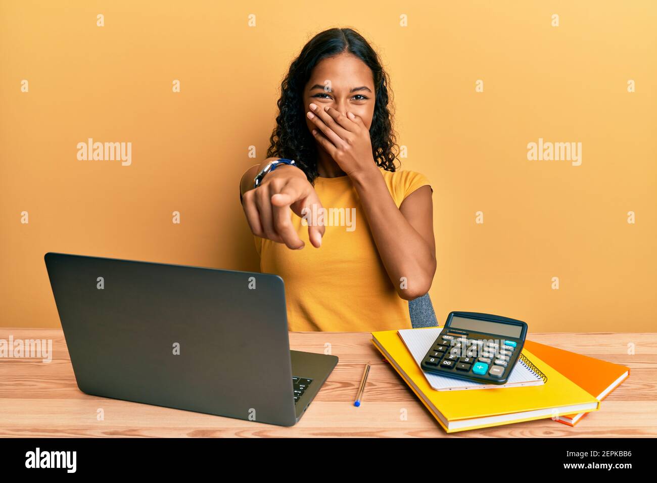 Young african american girl working at the office with laptop and ...
