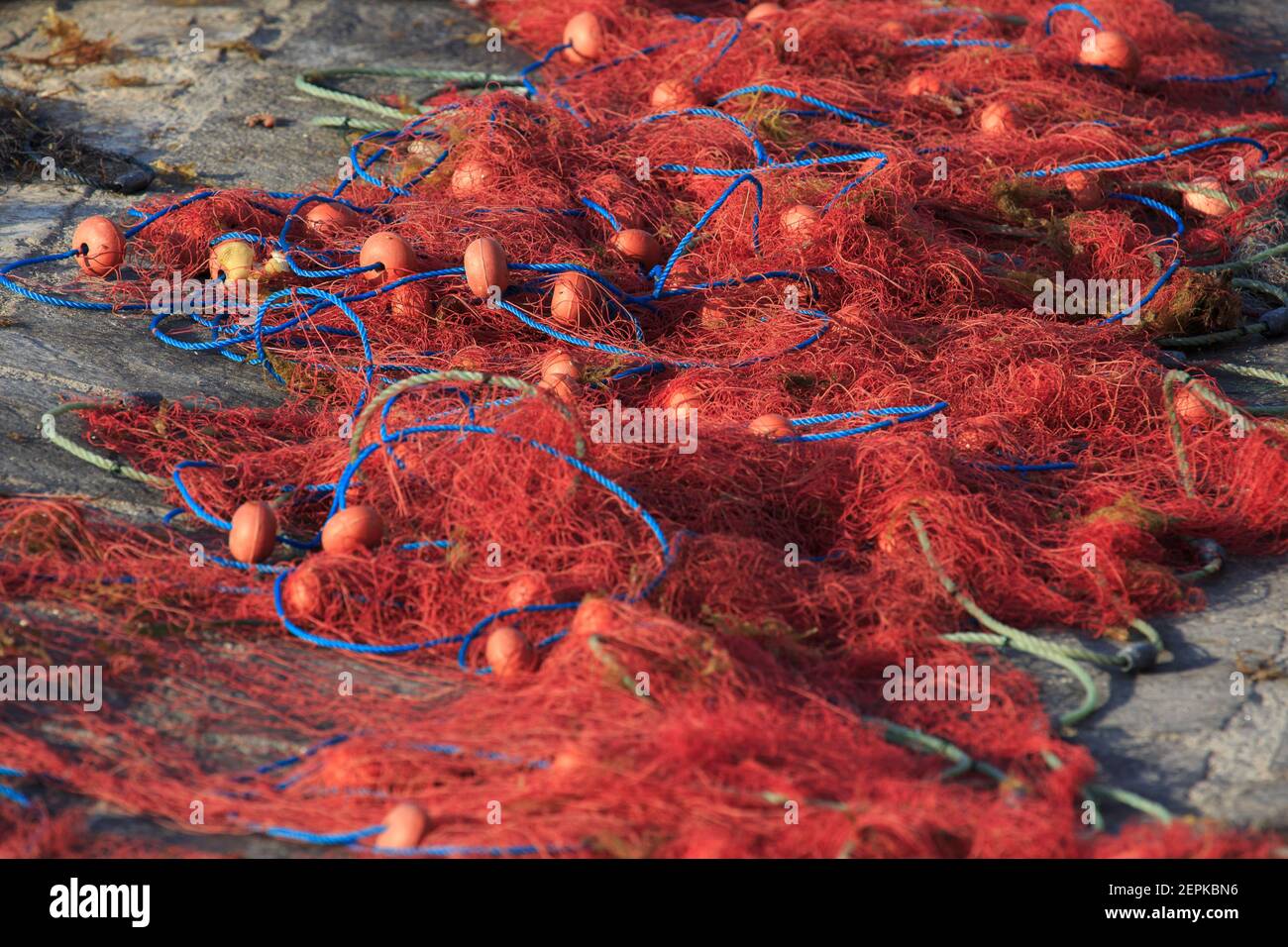 Red nylon fishing nets drying on shore in Marsaxlokk, Malta Stock Photo ...