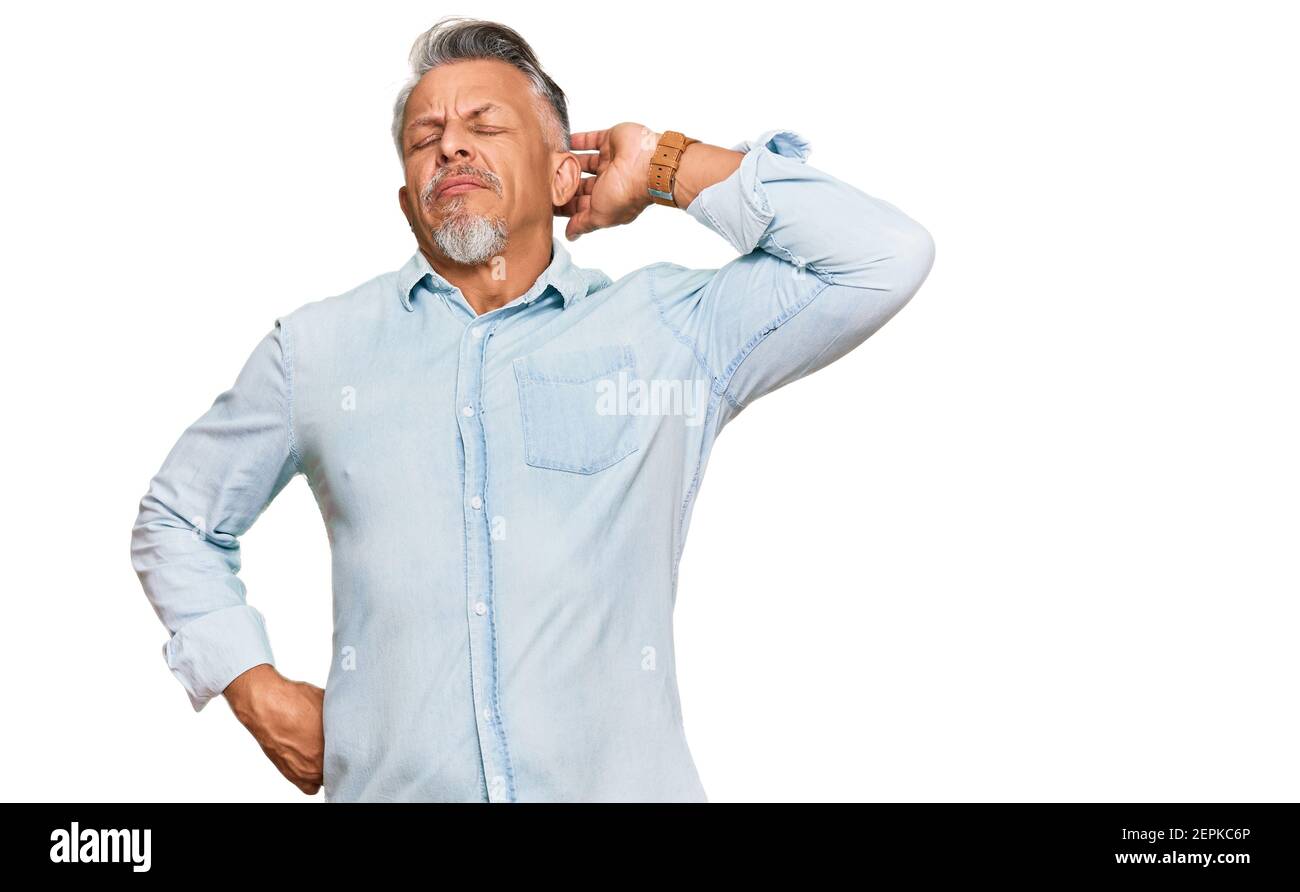 Middle age grey-haired man wearing casual clothes suffering of neck ...