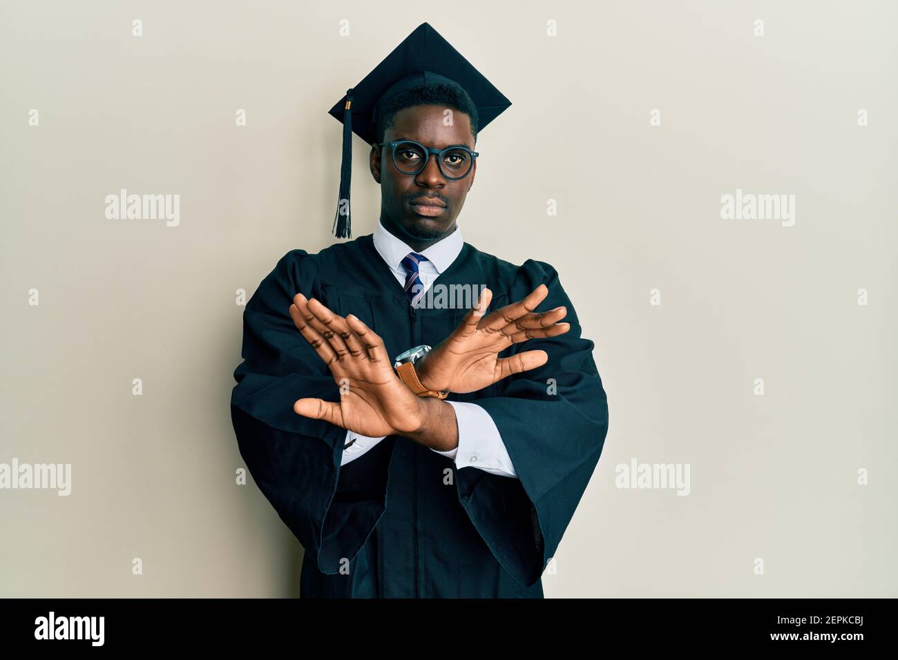 Handsome black man wearing graduation cap and ceremony robe rejection ...