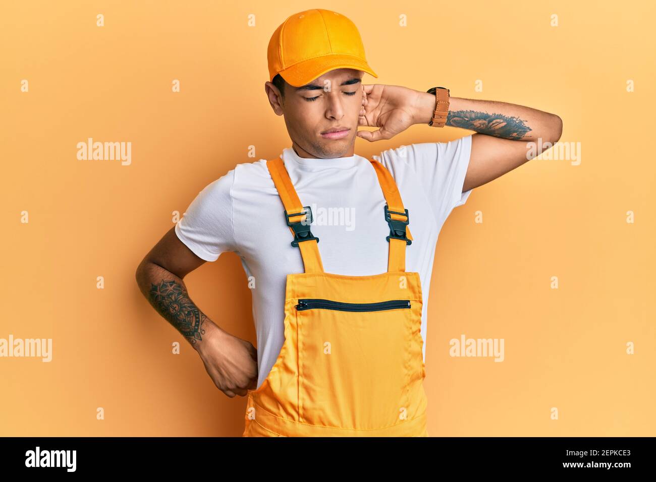 Young handsome african american man wearing handyman uniform over ...