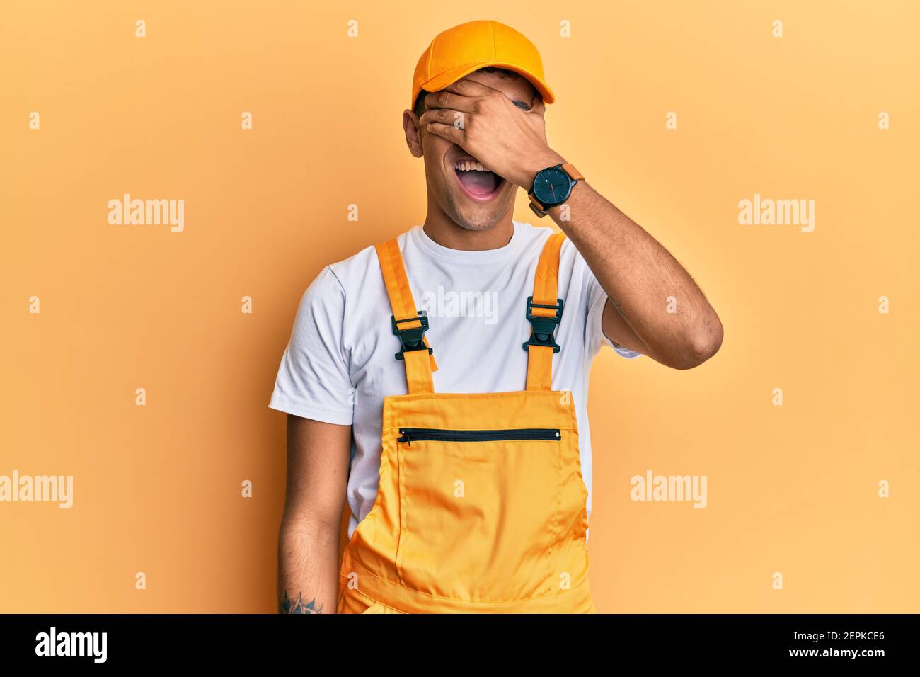 Young handsome african american man wearing handyman uniform over ...