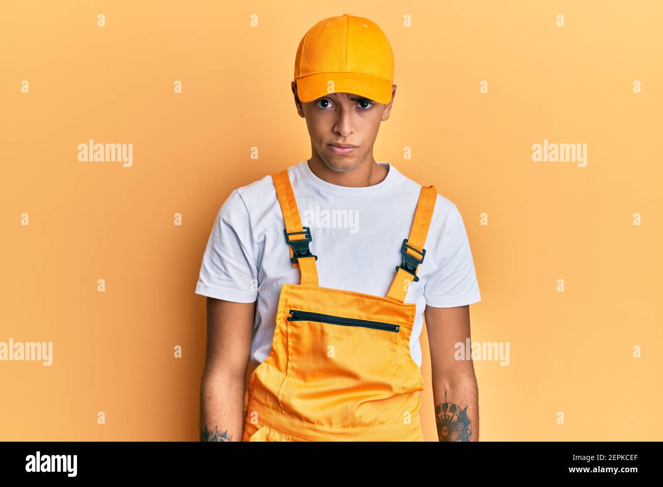 Young handsome african american man wearing handyman uniform over ...