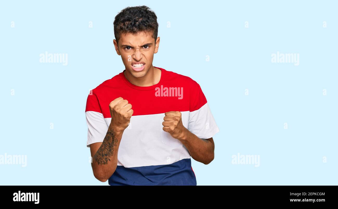 Young handsome african american man wearing casual clothes angry and ...