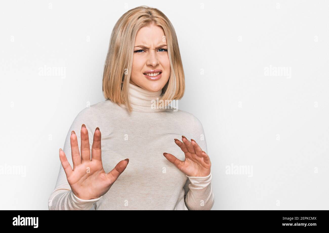Young blonde woman wearing casual clothes disgusted expression ...