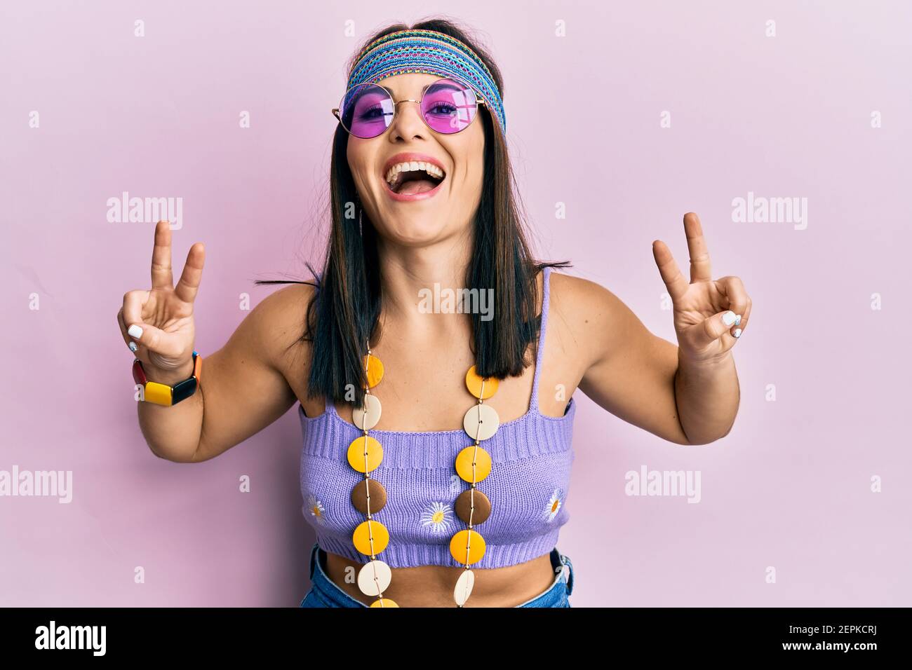 Young brunette woman wearing bohemian and hippie style doing peace ...