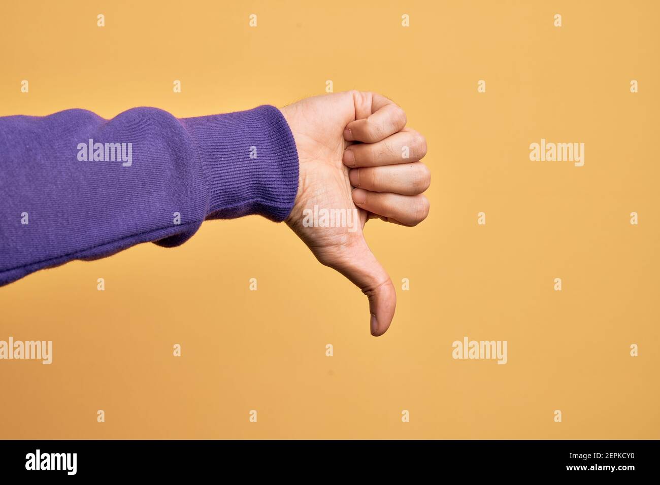 Hand of caucasian young man showing fingers over isolated yellow ...