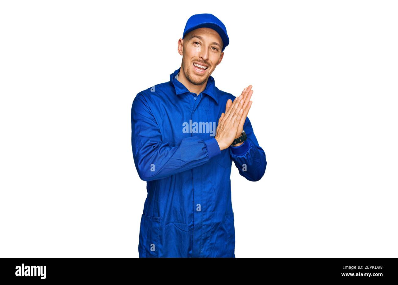 Bald man with beard wearing builder jumpsuit uniform clapping and ...