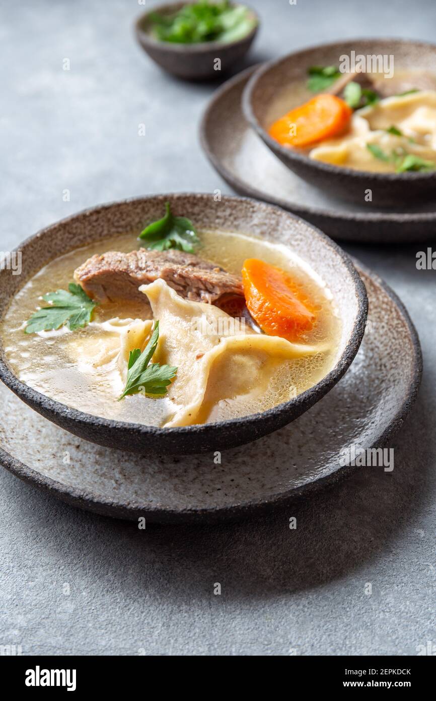 Traditional Jewish food dumplingd kreplach soup in gray bowl Stock ...