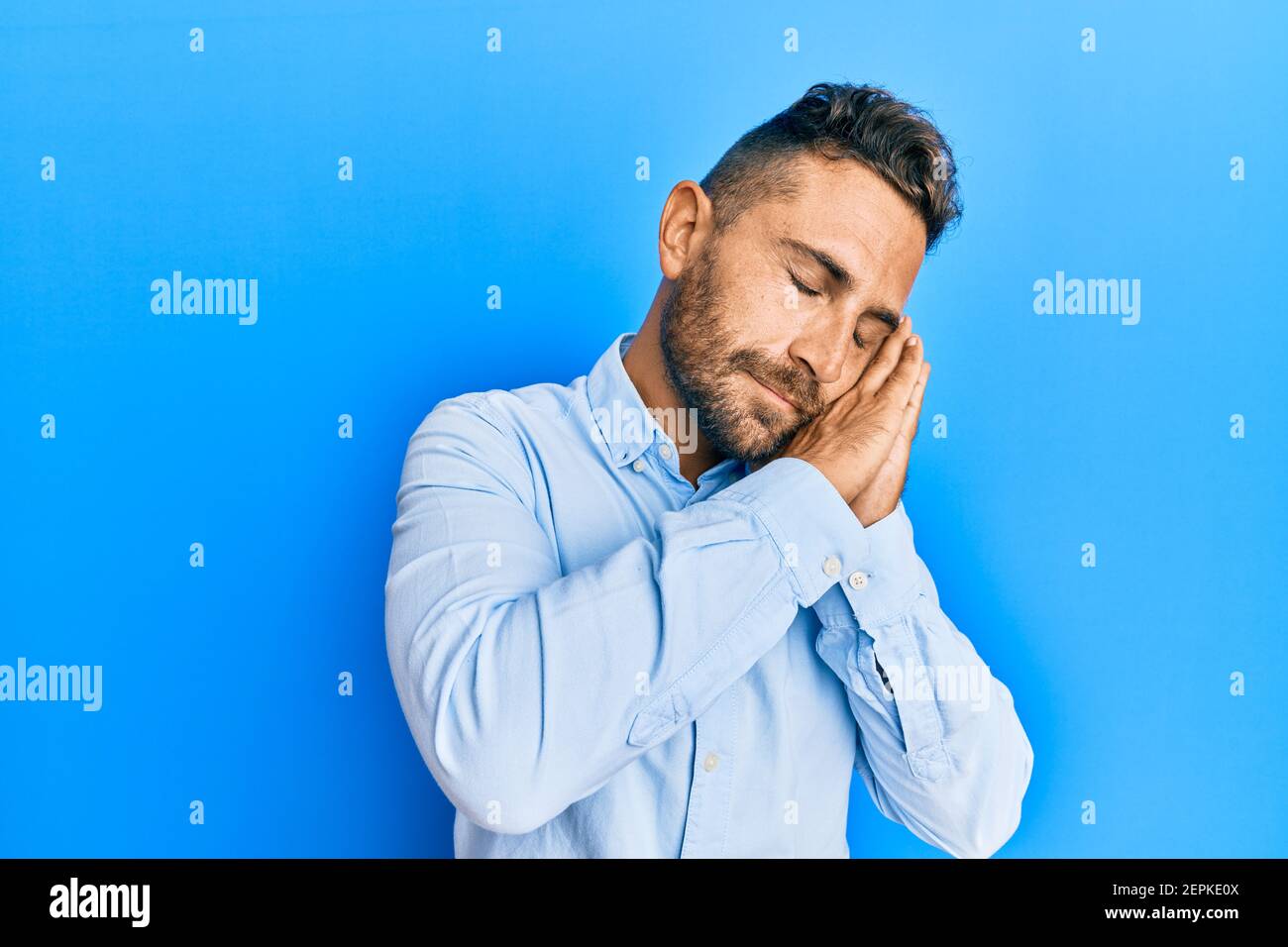 Handsome man with beard wearing casual clothes sleeping tired dreaming ...