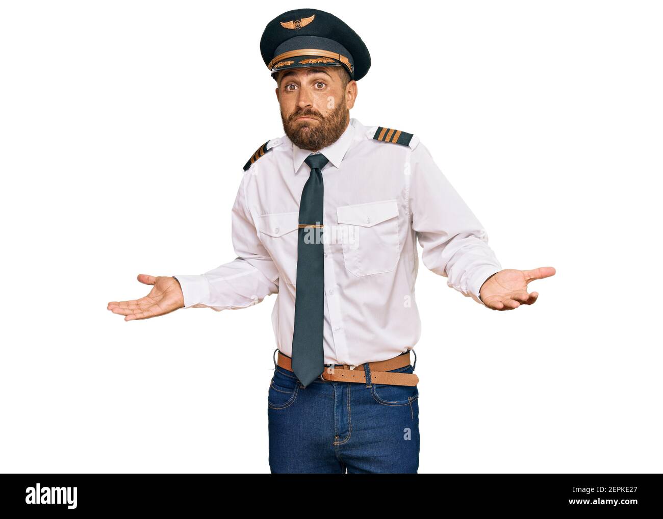 Handsome man with beard wearing airplane pilot uniform clueless and ...