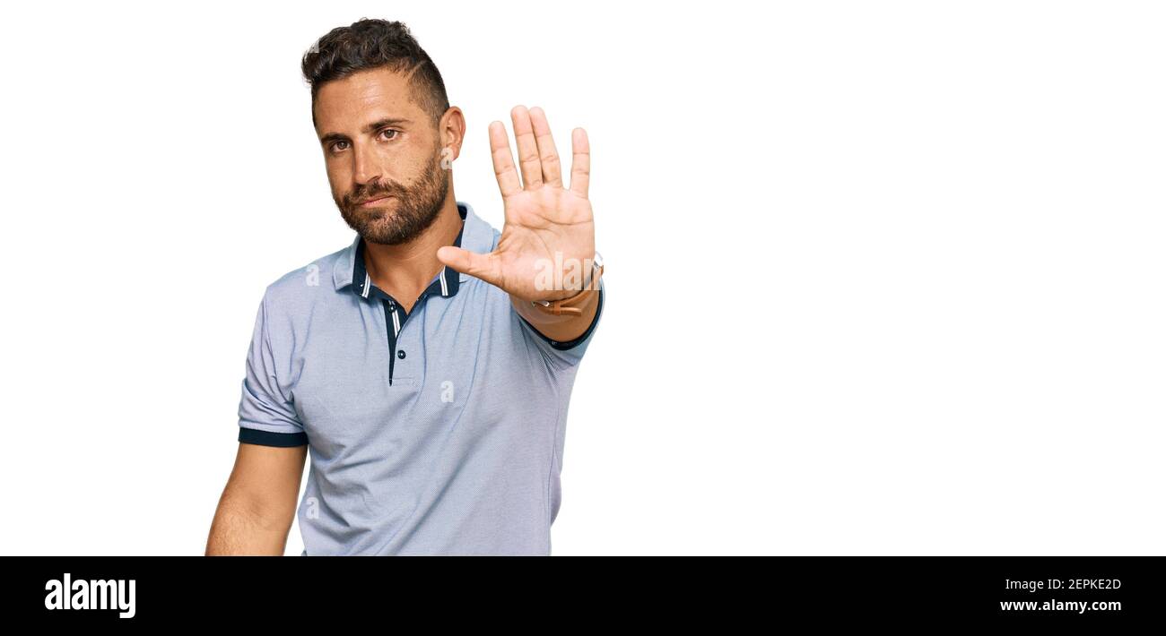 Handsome man with beard wearing casual clothes doing stop sing with ...