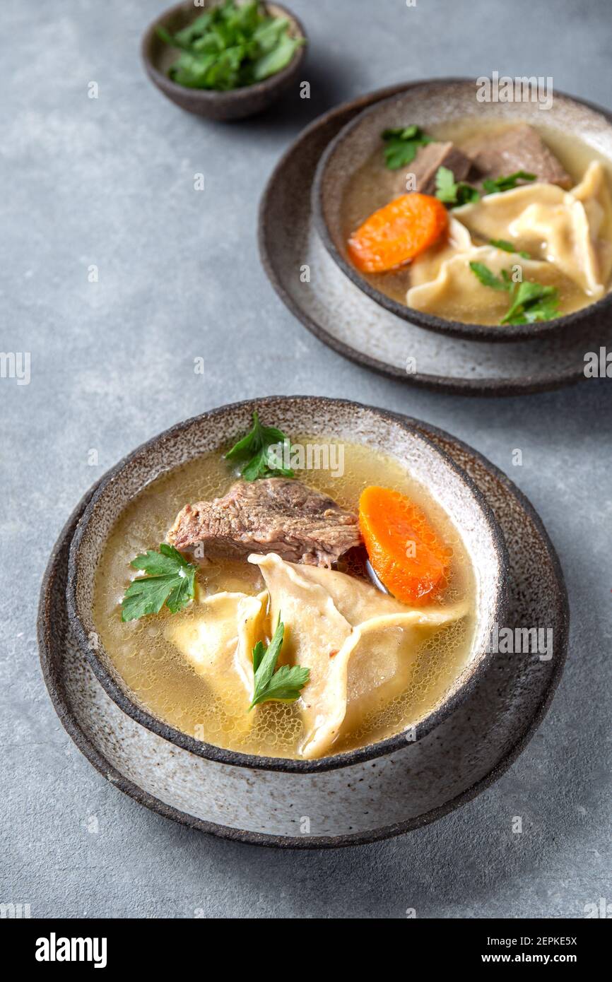 Traditional Jewish food dumplingd kreplach soup in gray bowl Stock ...