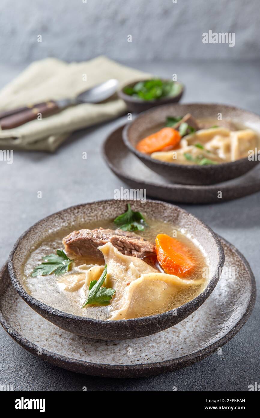 Traditional Jewish food dumplingd kreplach soup in gray bowl Stock ...