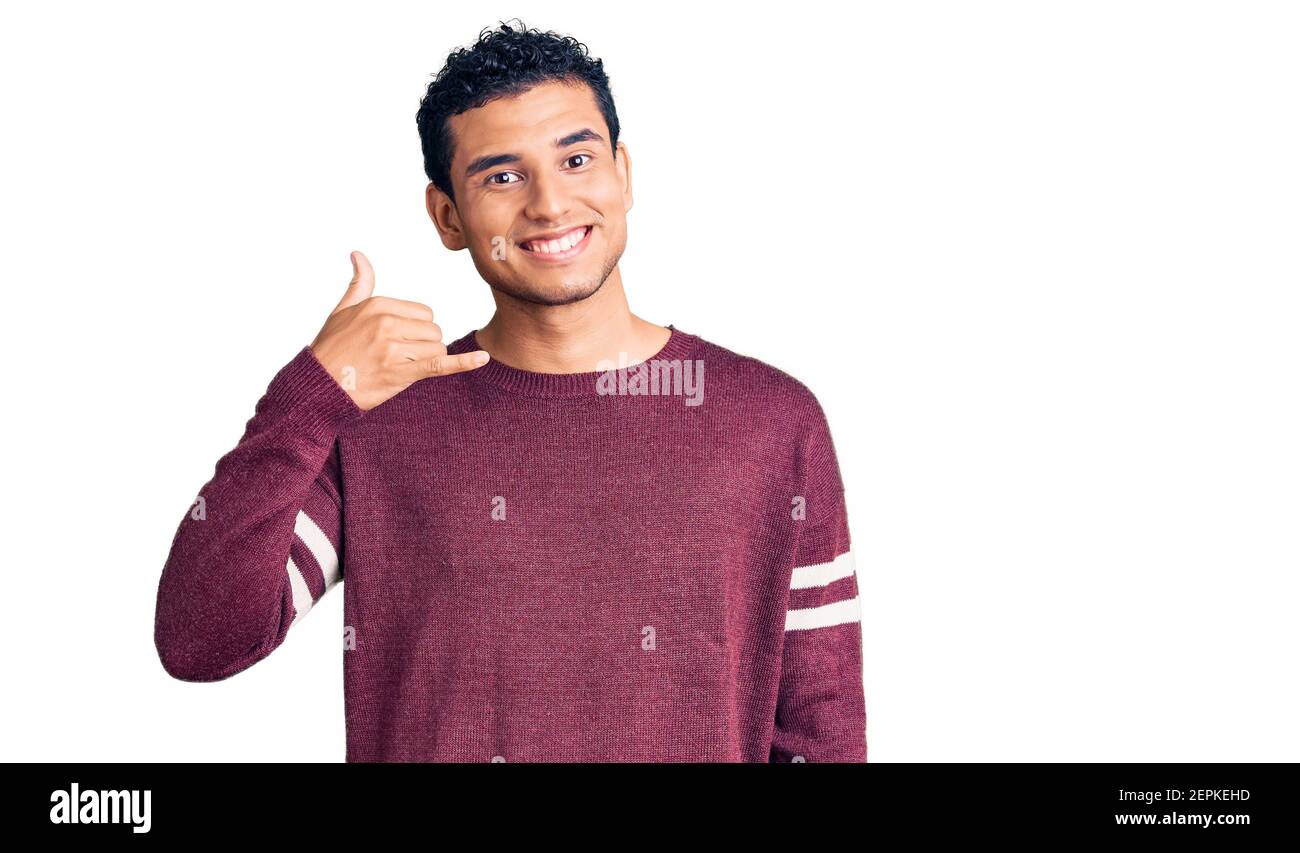 Hispanic handsome young man wearing casual clothes smiling doing phone ...