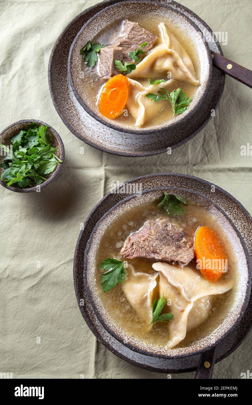 Traditional Jewish food dumplingd kreplach soup in gray bowl Stock ...
