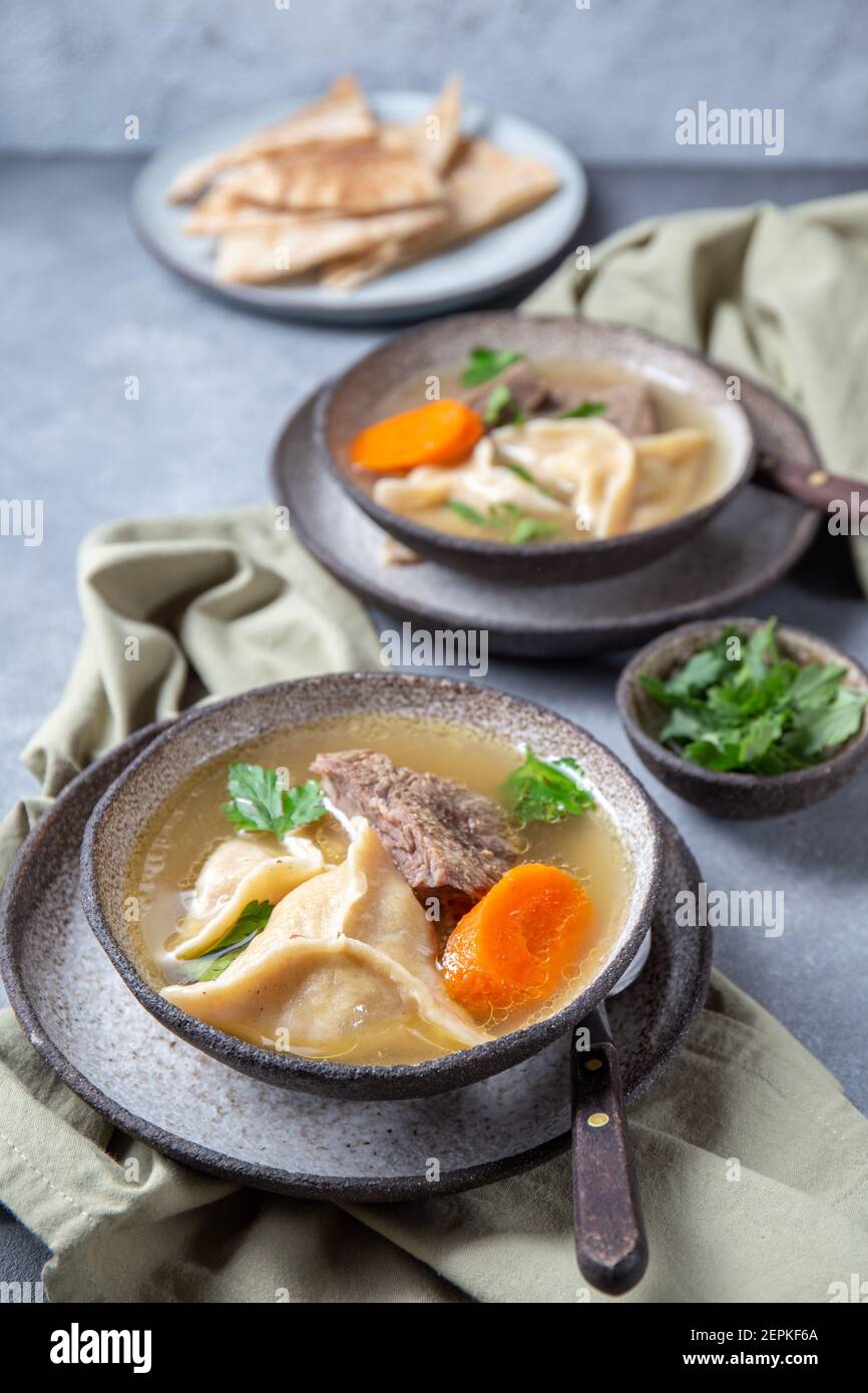 Traditional Jewish food dumplingd kreplach soup in gray bowl Stock ...