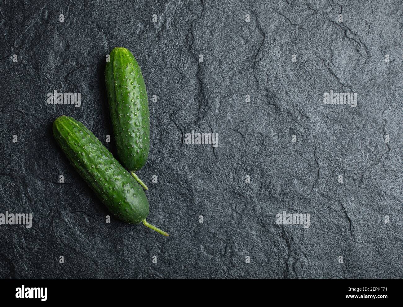 Top view two fresh cucumber on black background Stock Photo - Alamy