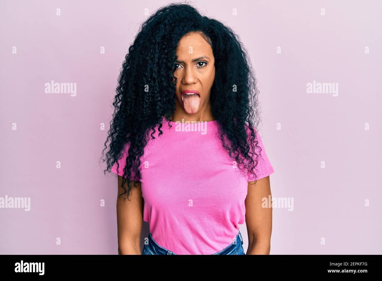 Middle age african american woman wearing casual clothes sticking ...